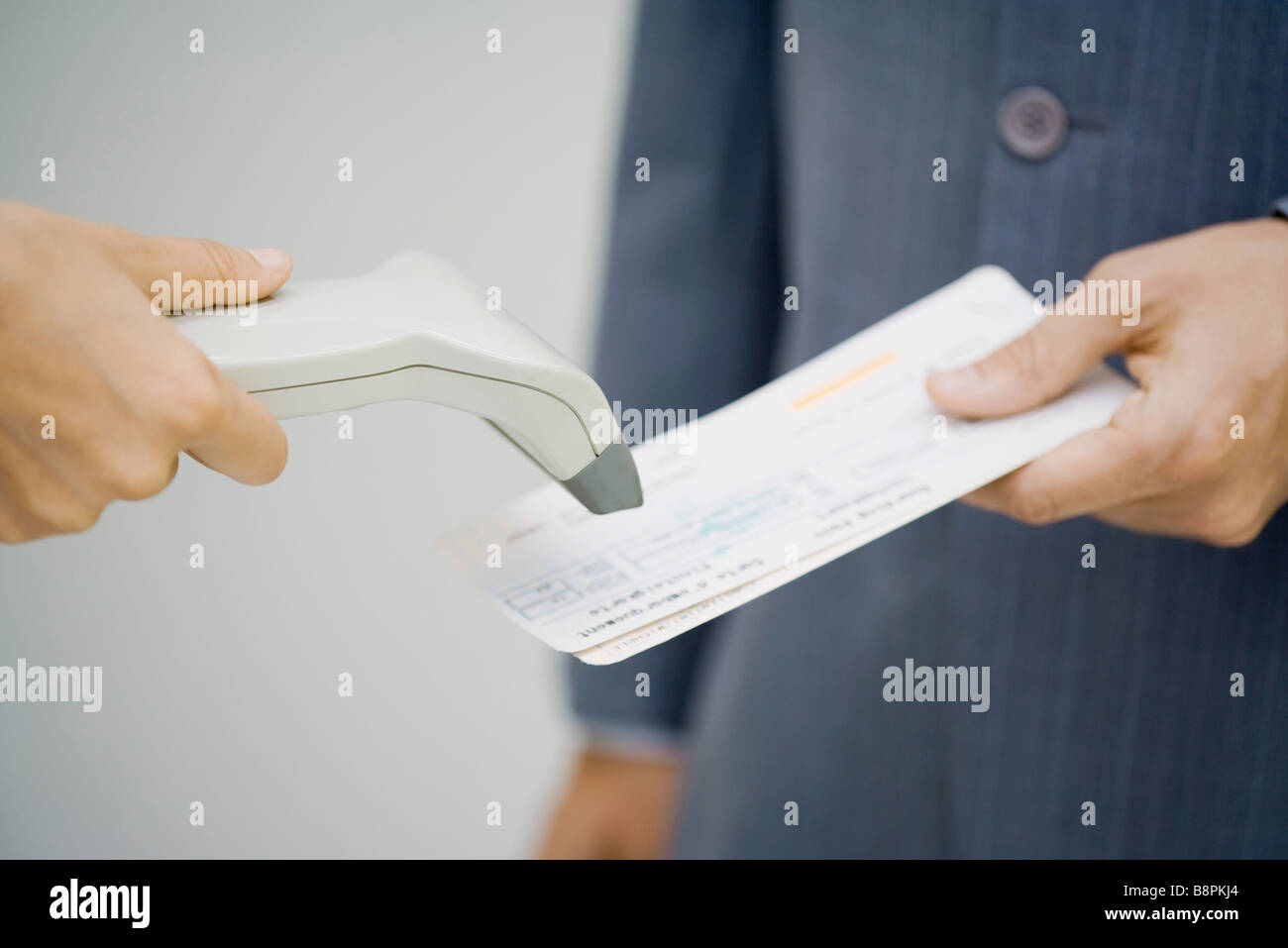 Man's plane tickets being scanned Stock Photo - Alamy