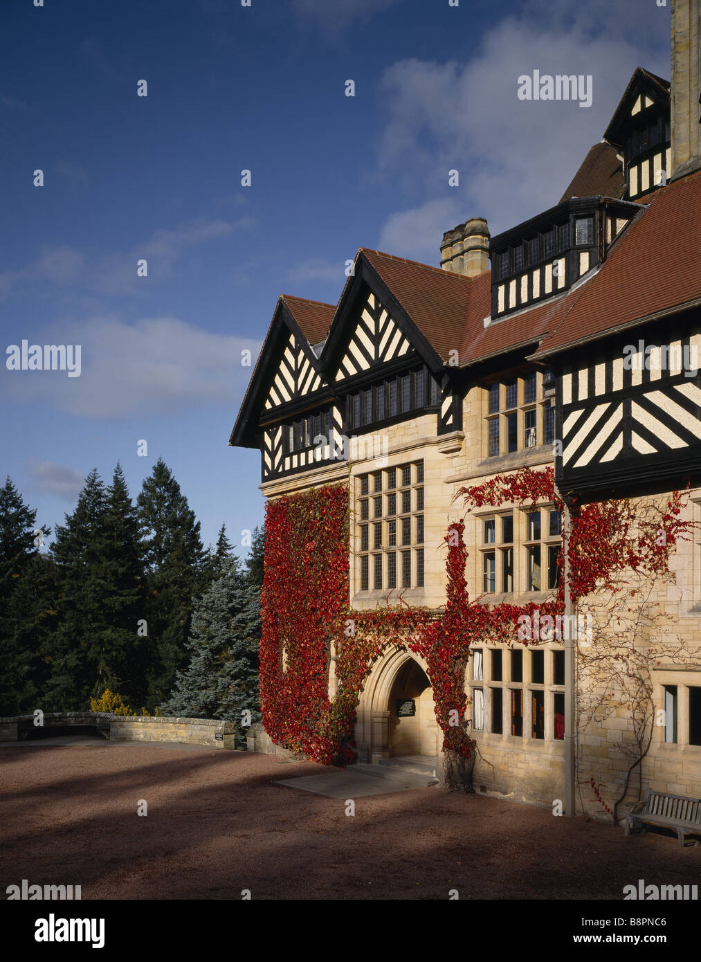 Oblique view of the entrance with virginia creeper round door Showing ...