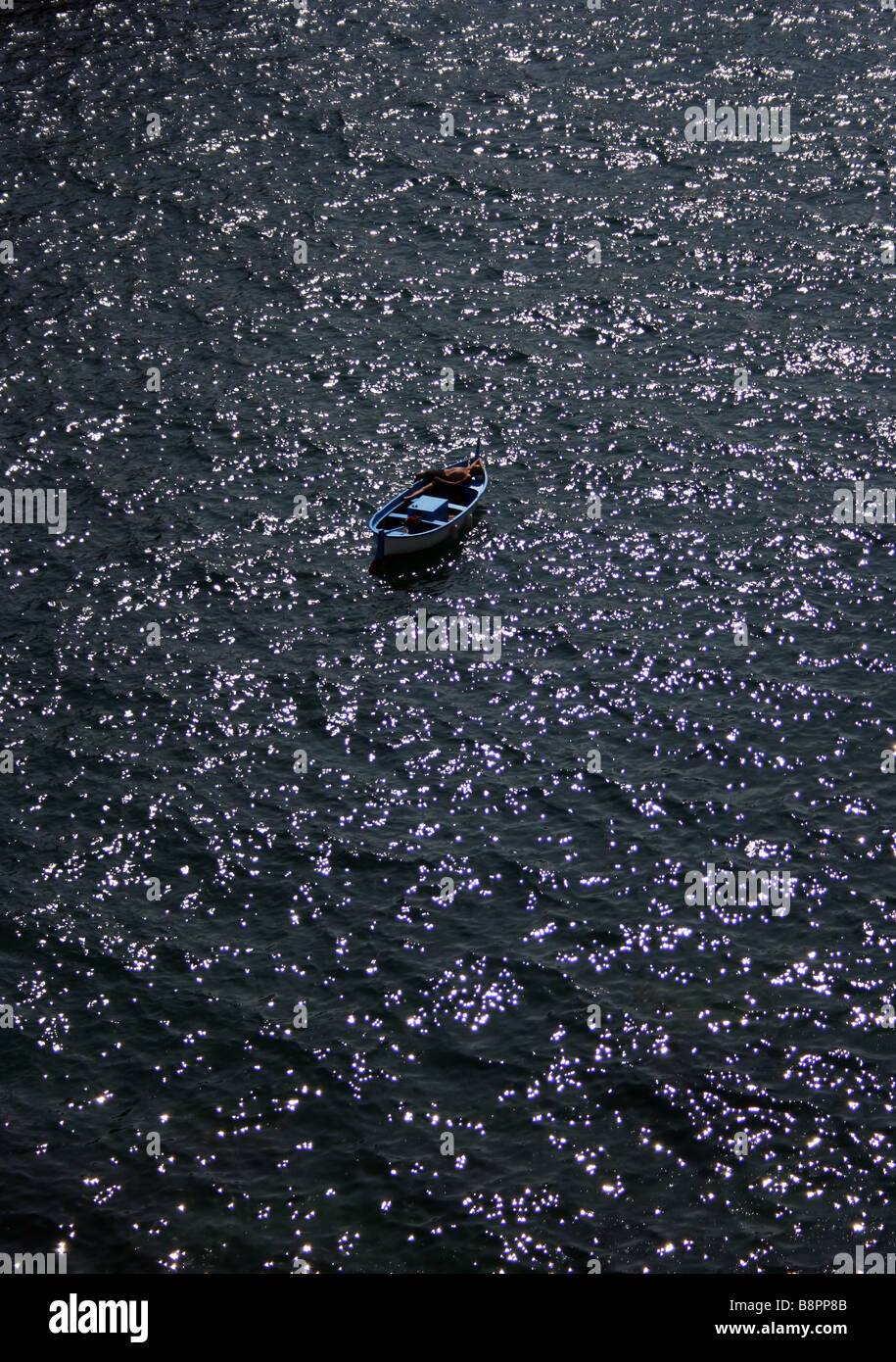 Man relaxing in a small boat on the Mediterranean Sea, 2007 Stock Photo ...