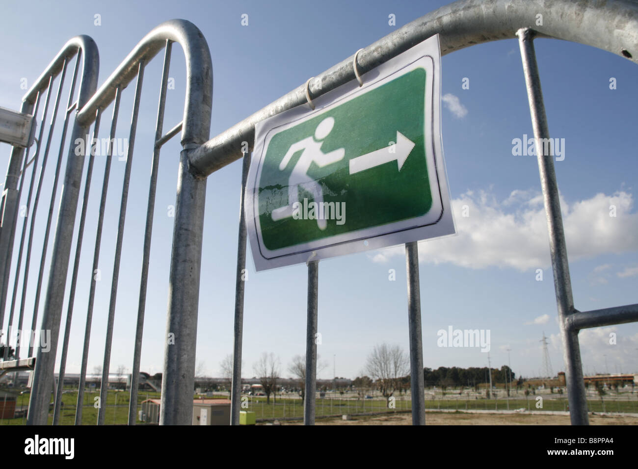 emergency exit sign on barrier fence outdoors Stock Photo - Alamy