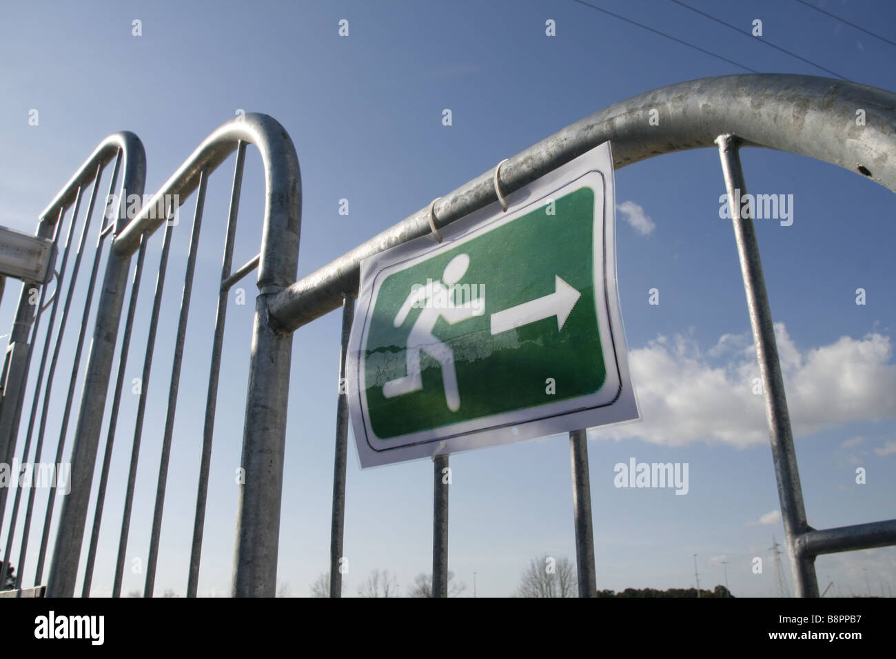 emergency exit sign on barrier fence outdoors Stock Photo - Alamy