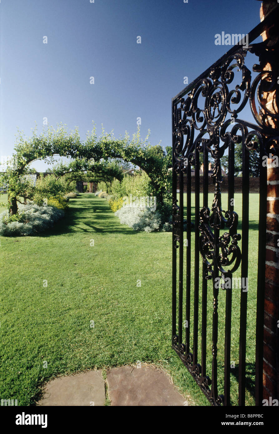 Open wrought iron gate at Beningbrough Hall leading to a colourful ...