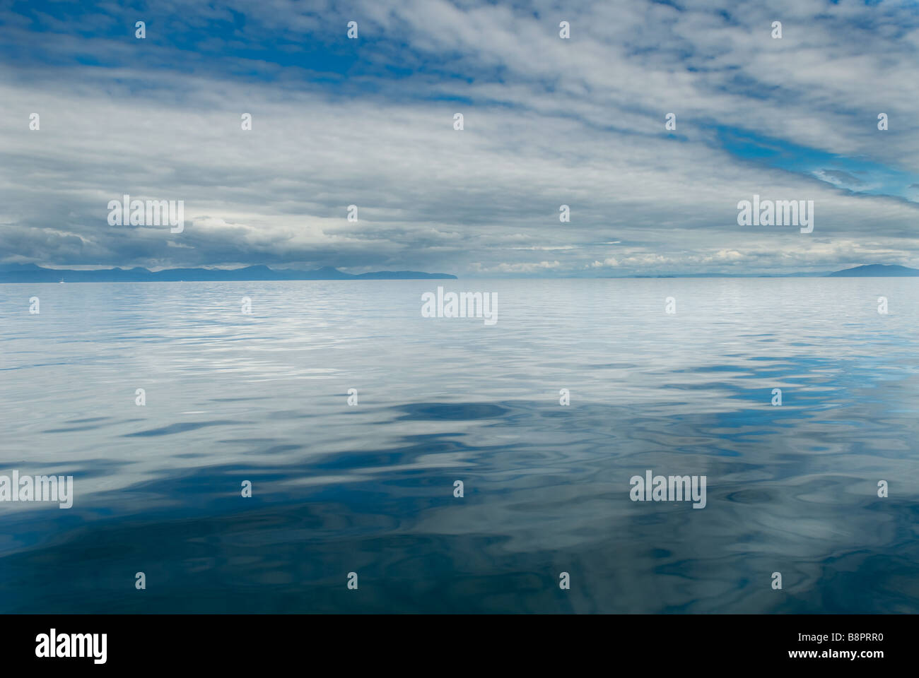 photograph of calm sea with reflected sky Stock Photo - Alamy