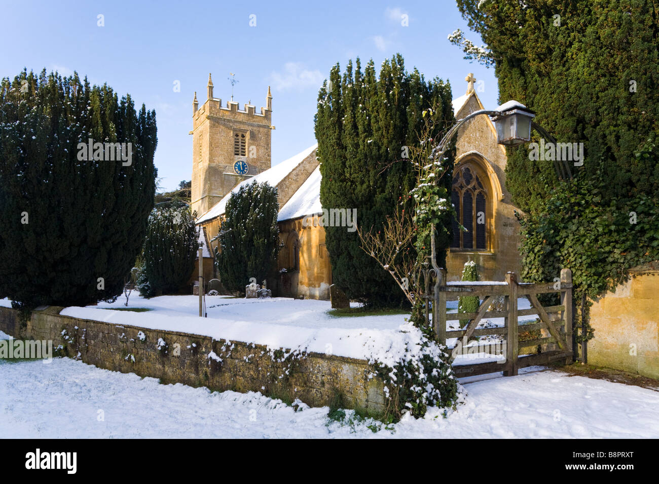 Winter snow at St Peters church in the Cotswold village of Stanway ...