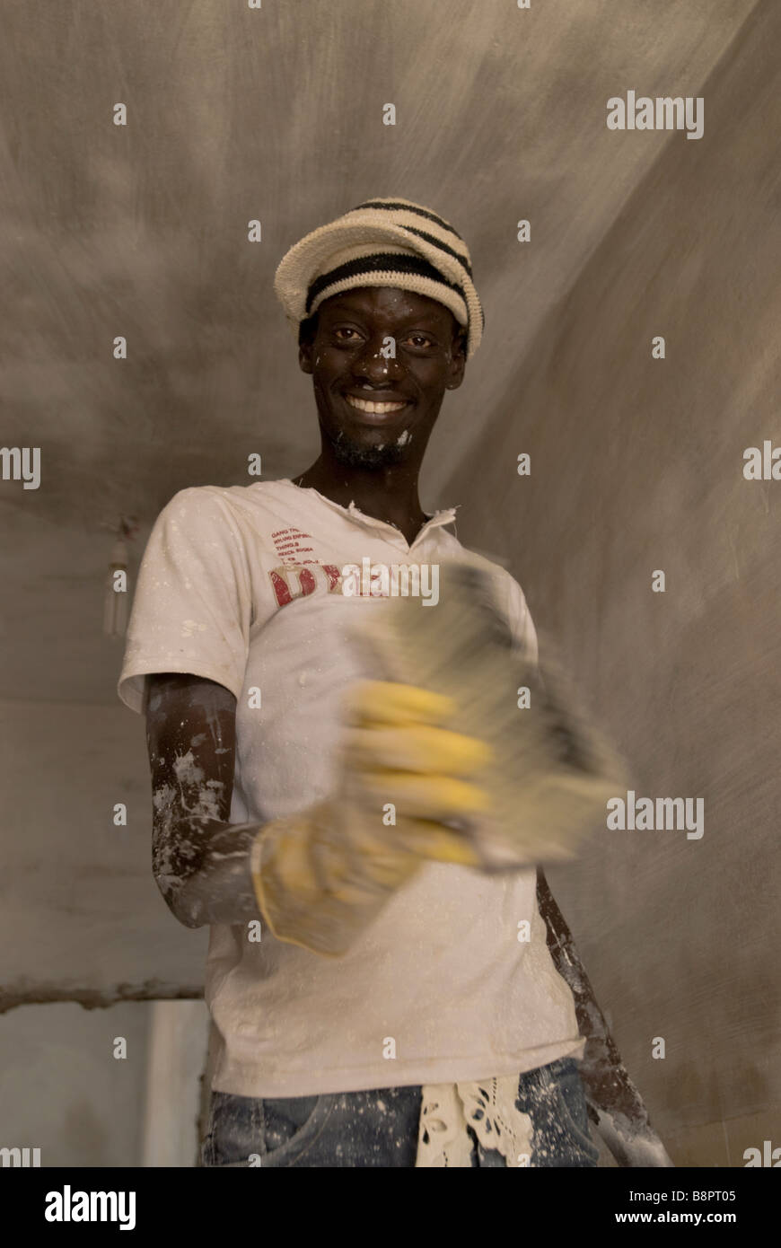 portrait of a jung african man plastering decorating a corridor Stock ...