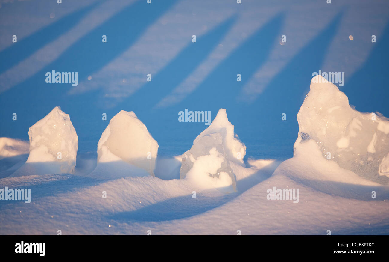 Row of jagged ice blocks sticking out of snow on sea ice , Finland ...