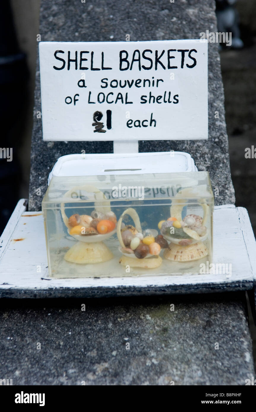 Hand made tourist souvenirs of shell baskets for sale outside a local ...