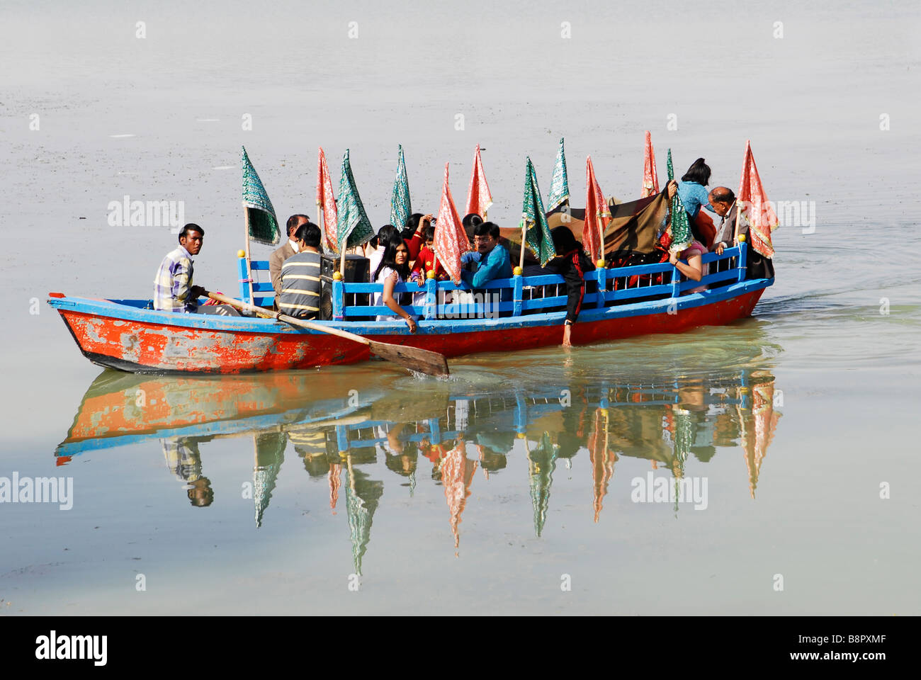 Boat carrying tourists and pilgrims around a sacred lake, Rajasthan ...