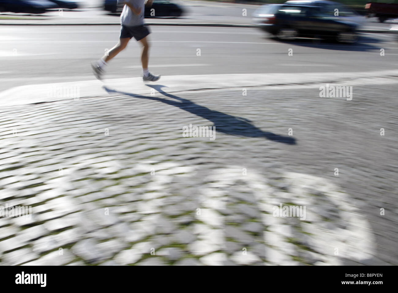 one fast runner in action on street in city town Stock Photo - Alamy