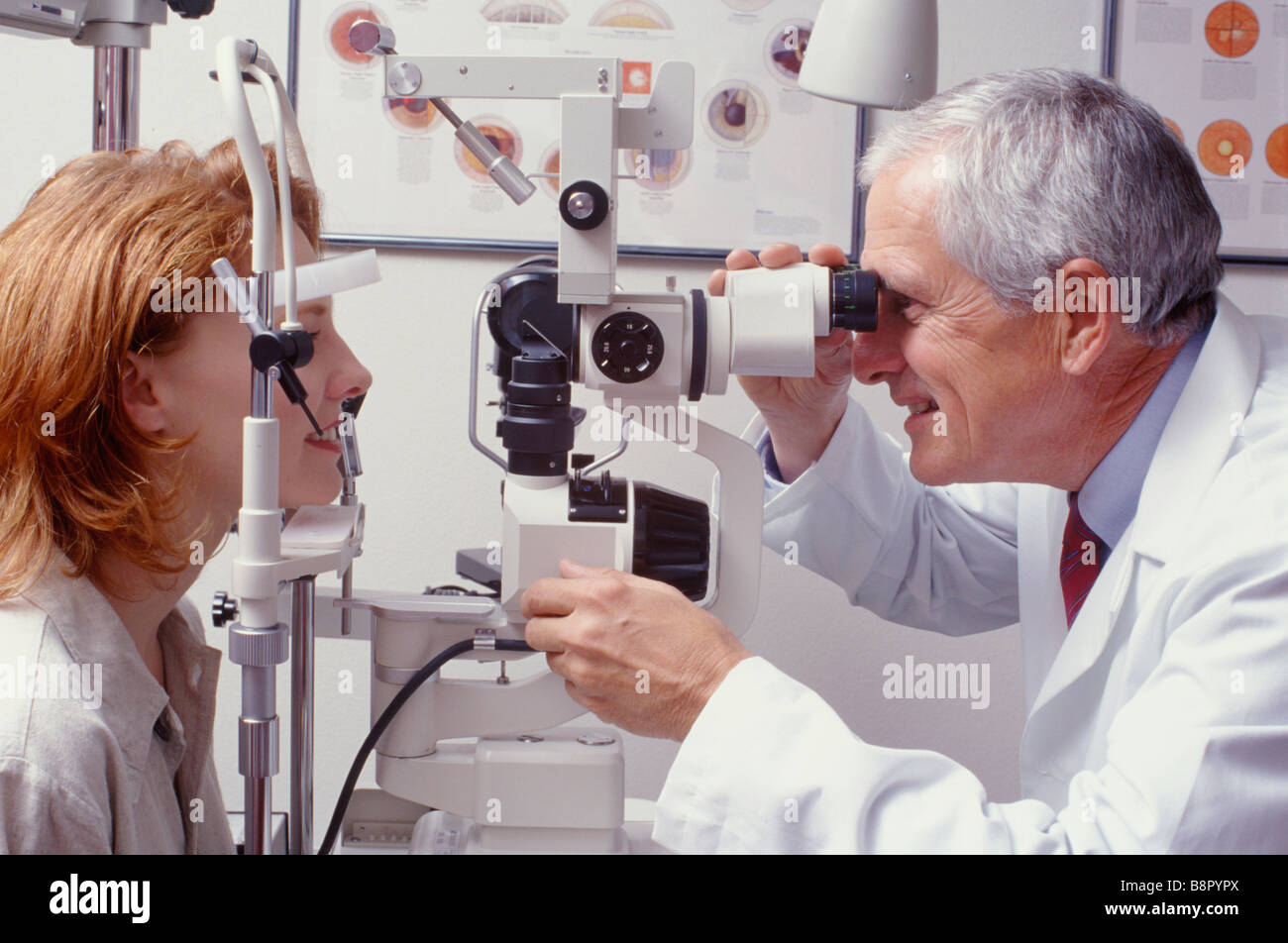 optometrist with patient, giving an eye examination Stock Photo - Alamy