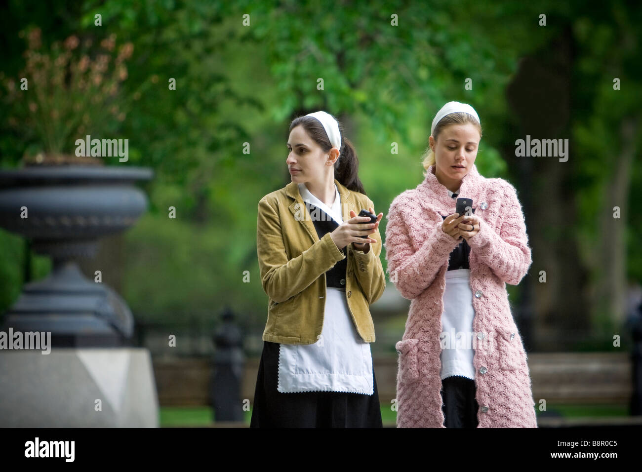Nannies checking cell phones (editorial use only Stock Photo - Alamy