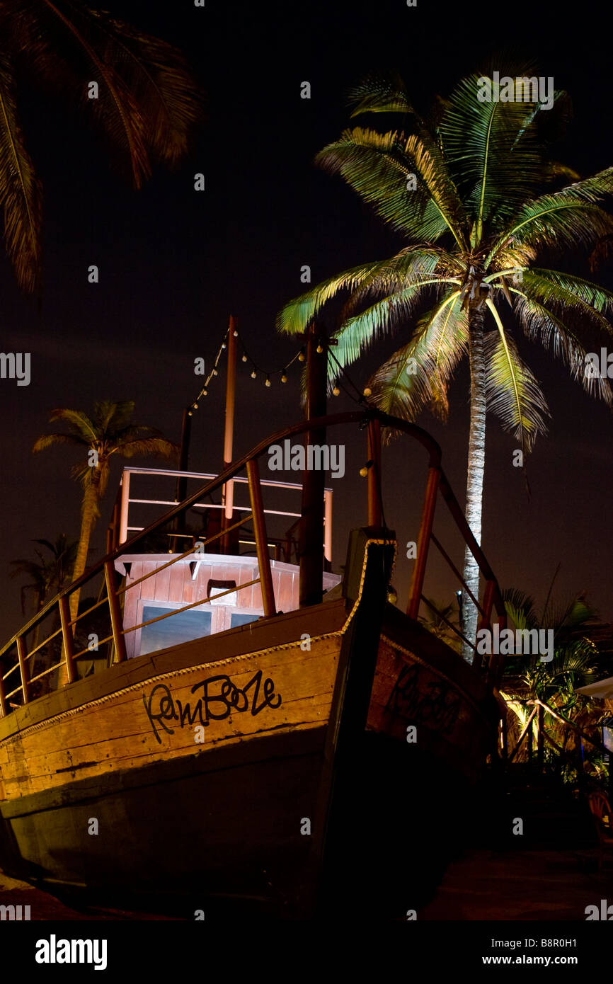 Tropical nigth scene with illuminated boat and palm Stock Photo - Alamy