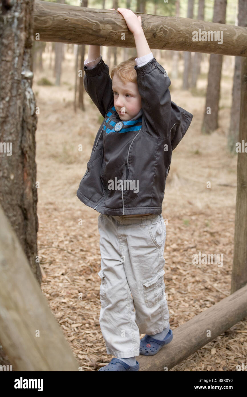 Boy balancing in an adventure playground Stock Photo - Alamy