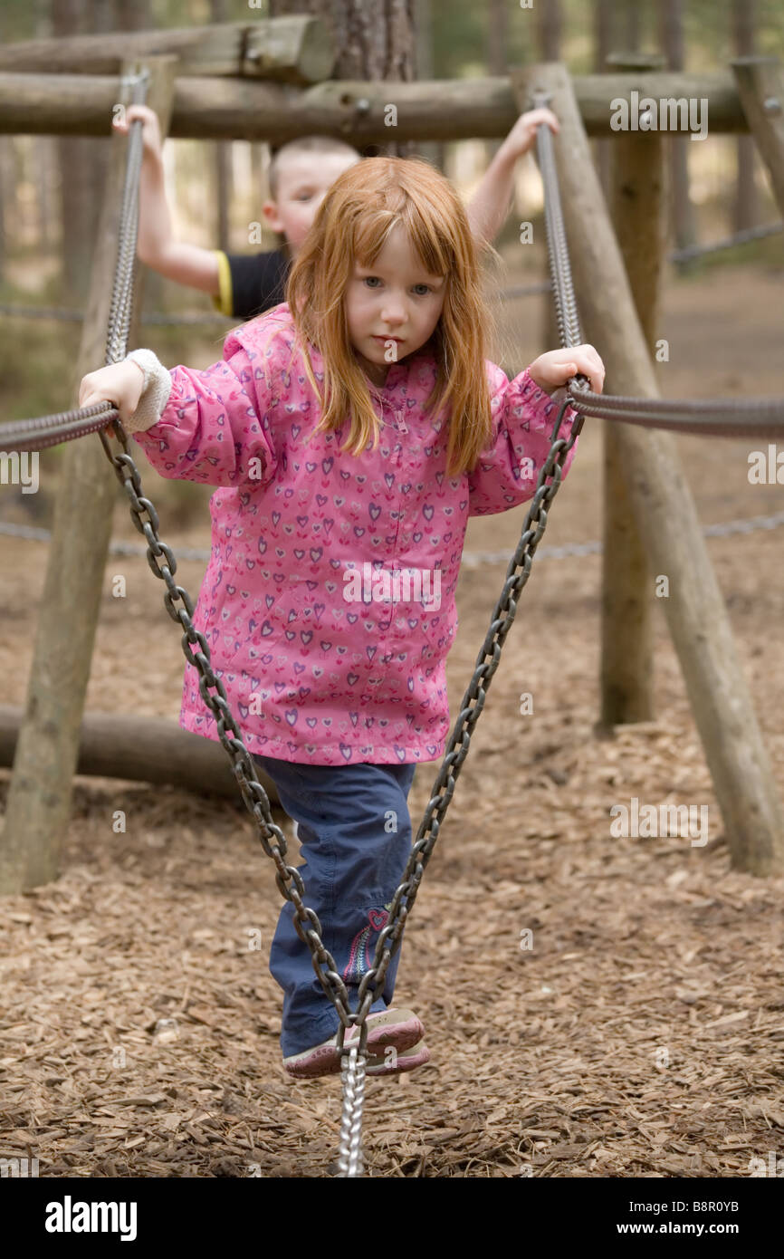 Girl balancing in an adventure playground Stock Photo - Alamy