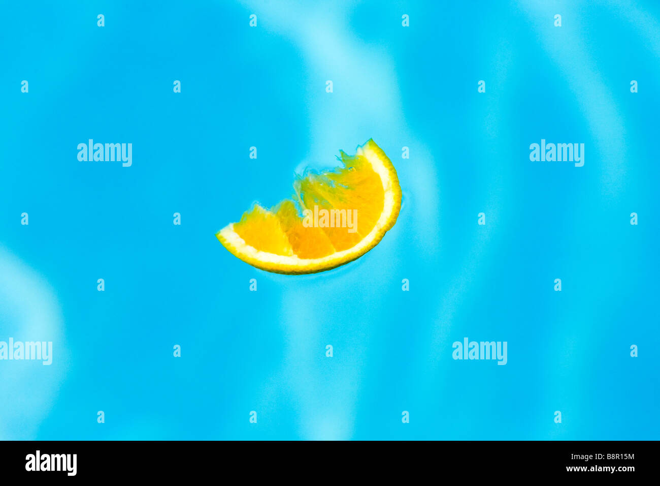 A slice of orange floats on water in a swimming pool Stock Photo - Alamy