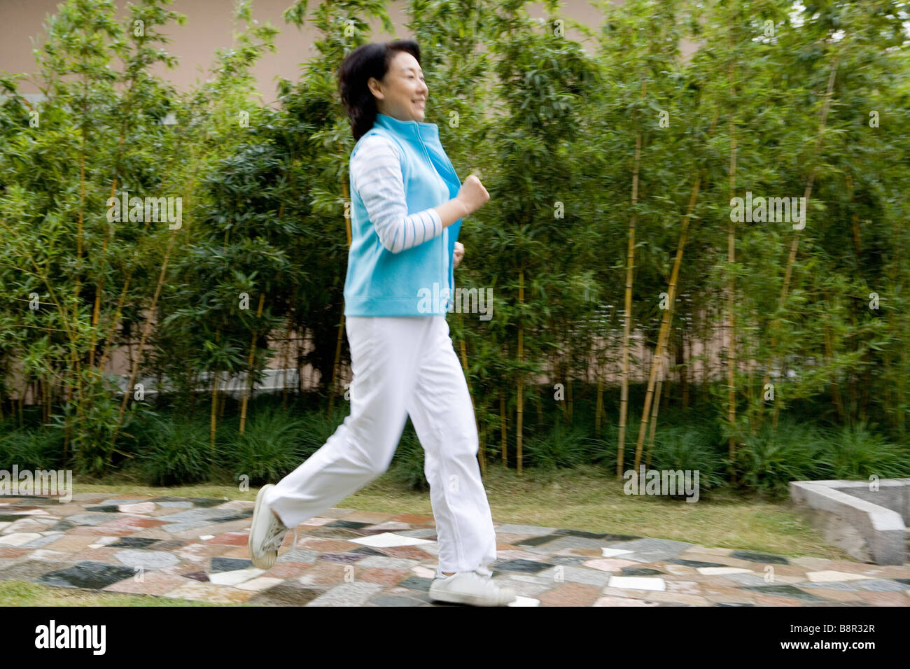 Senior woman jogging in the park Stock Photo - Alamy