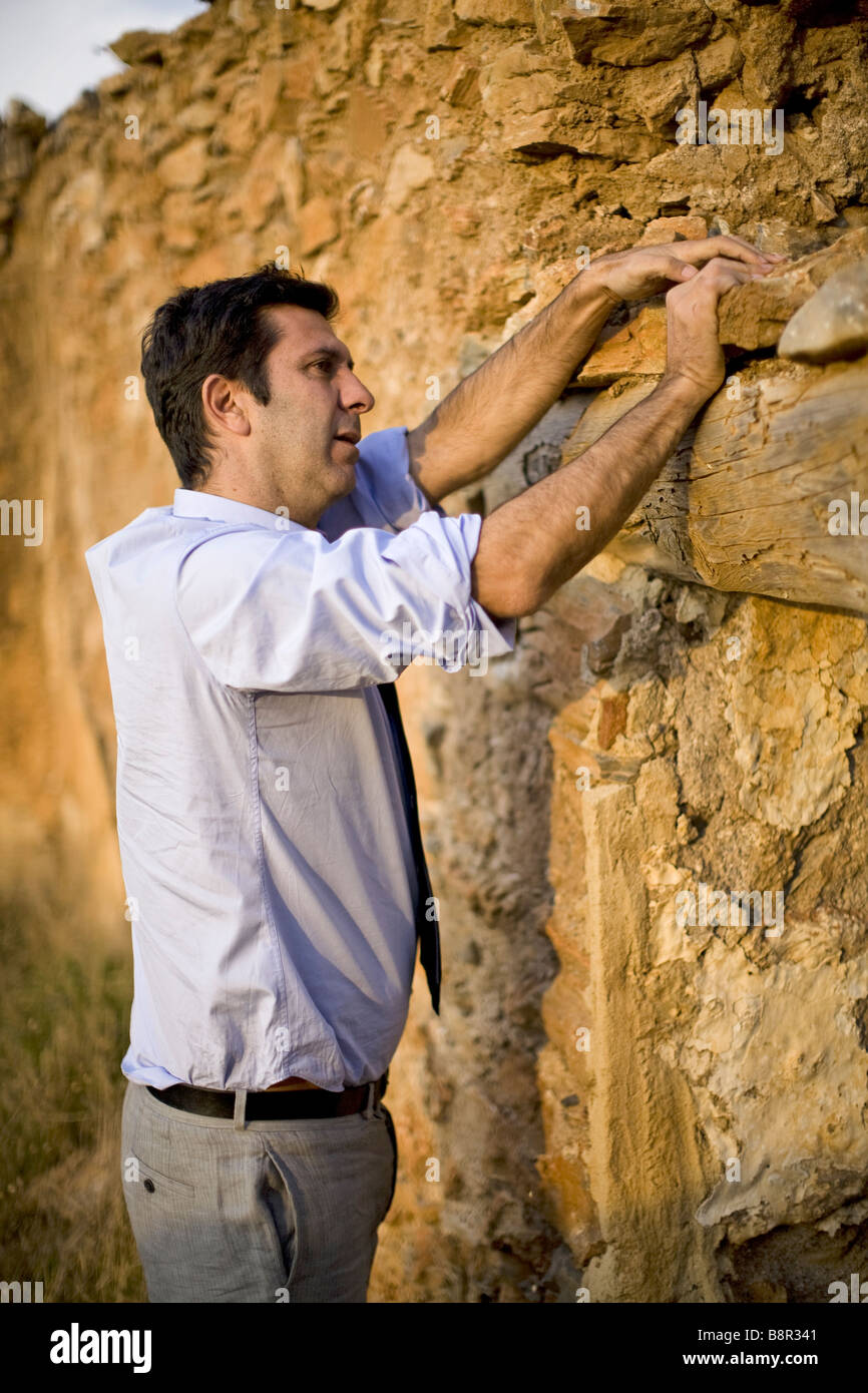 Business man rebuilding his ruined house Stock Photo - Alamy
