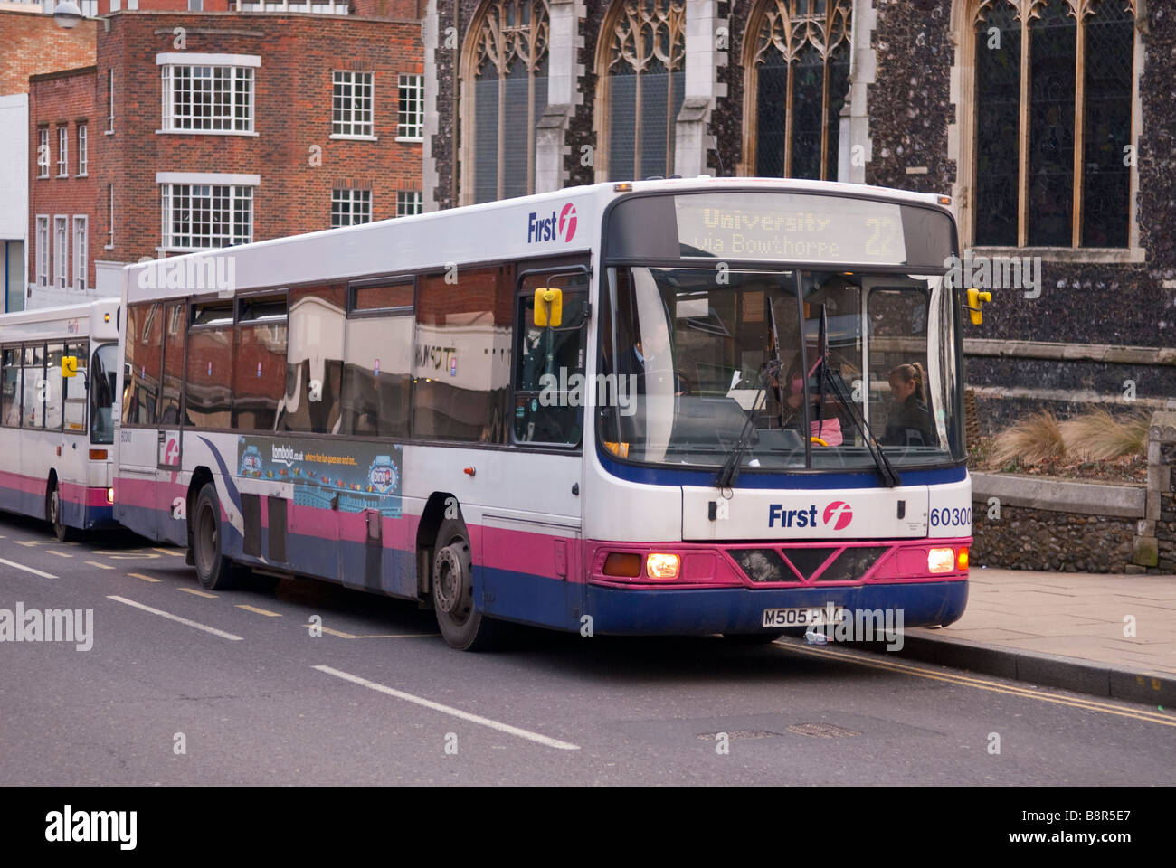 A first livery public transport single deck bus picking people up in ...