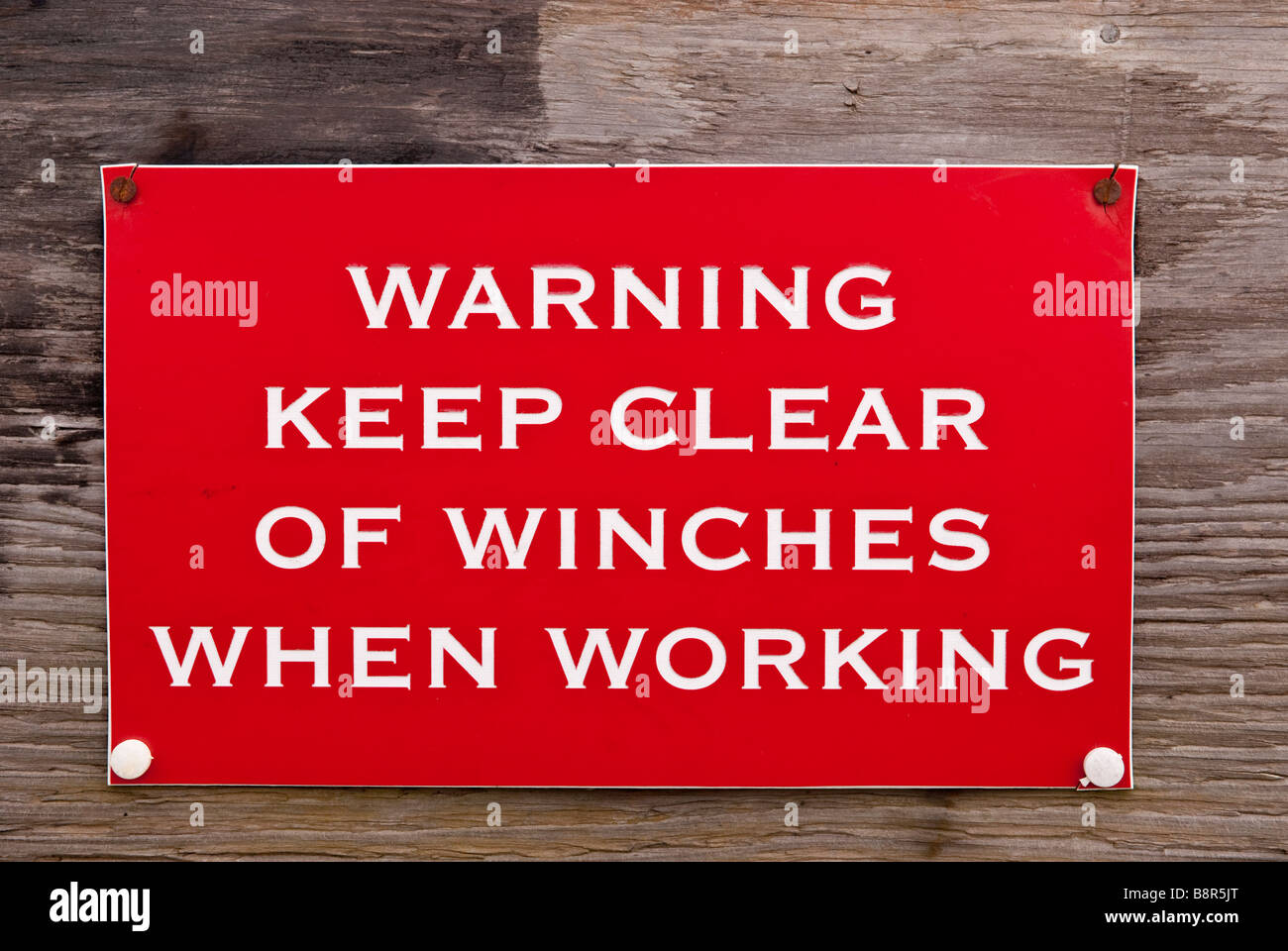 Warning keep clear of winches when working sign Stock Photo - Alamy
