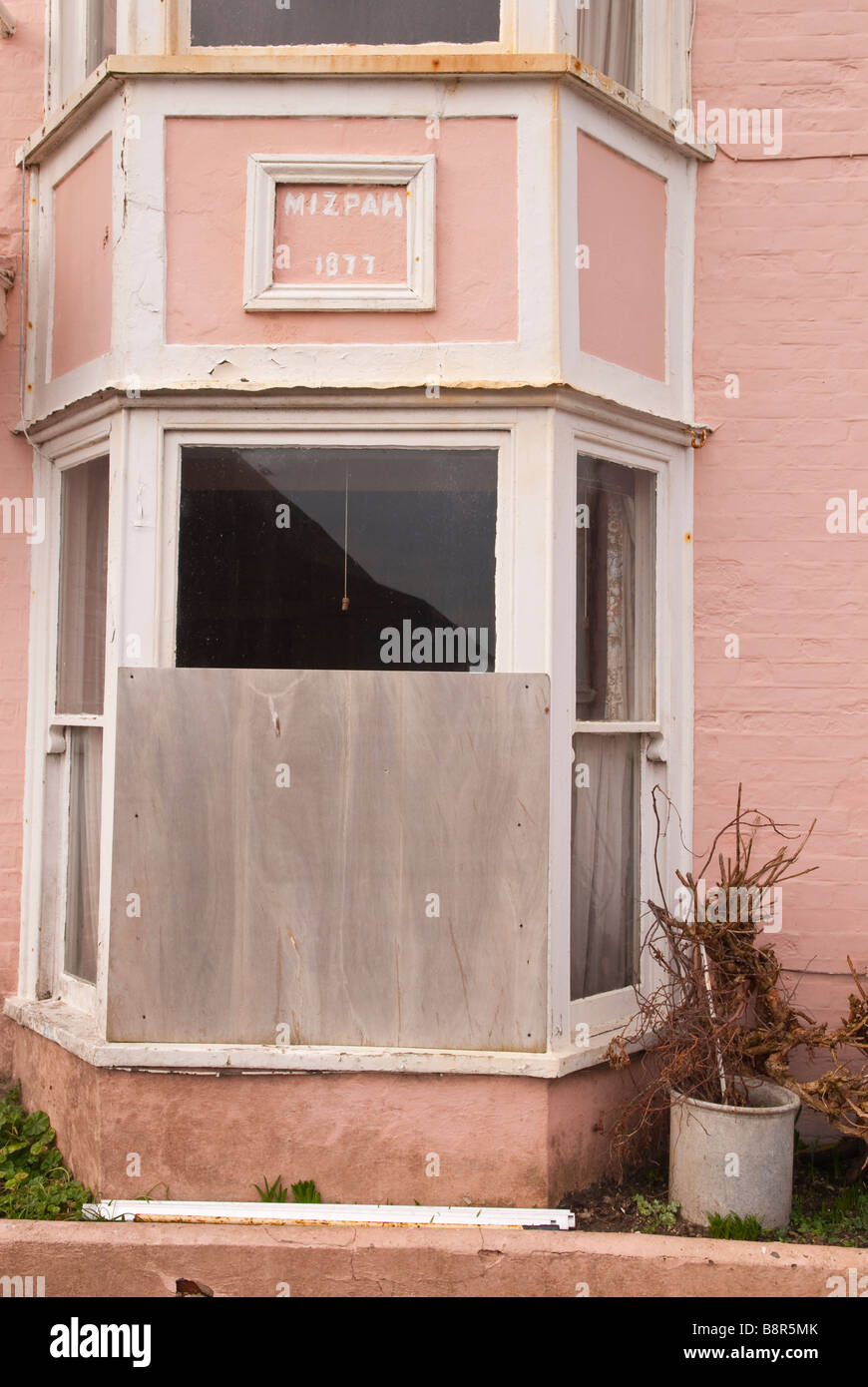 A boarded up window of a run down house Stock Photo - Alamy
