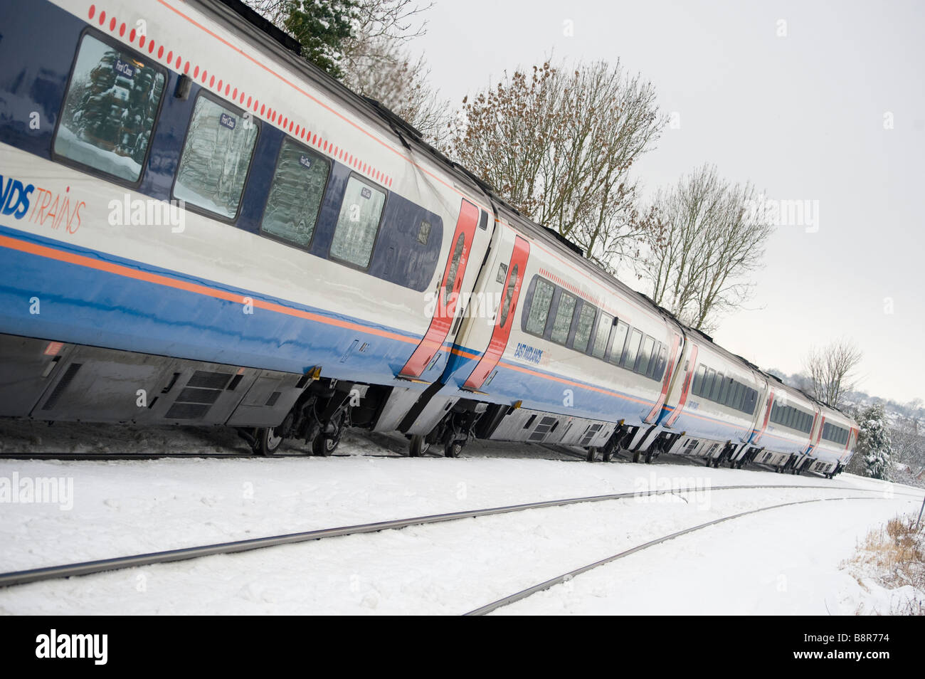 High speed train in East Midlands Trains livery travelling through snow ...