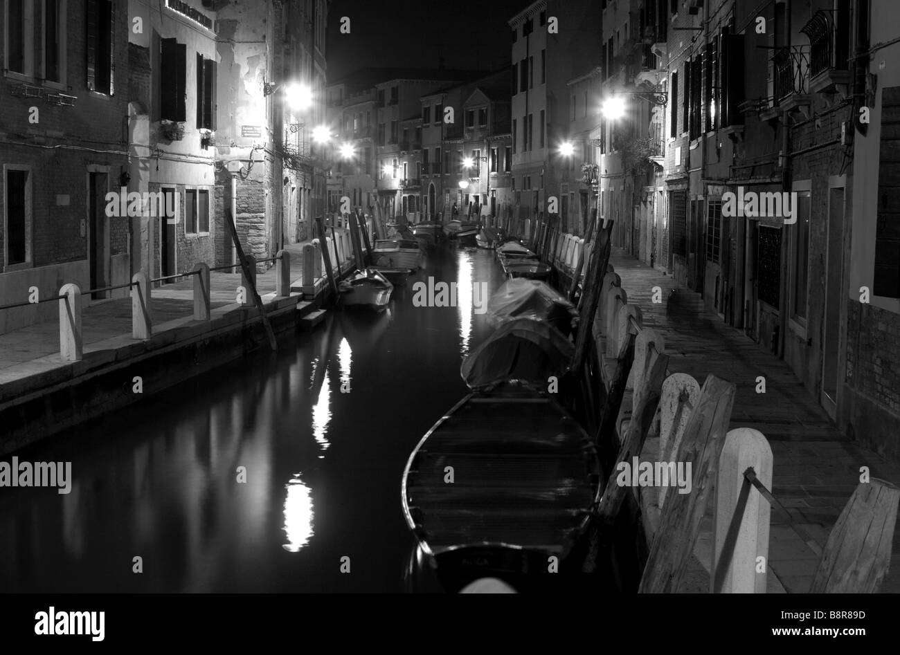 Venice - canal in night and boats Stock Photo - Alamy