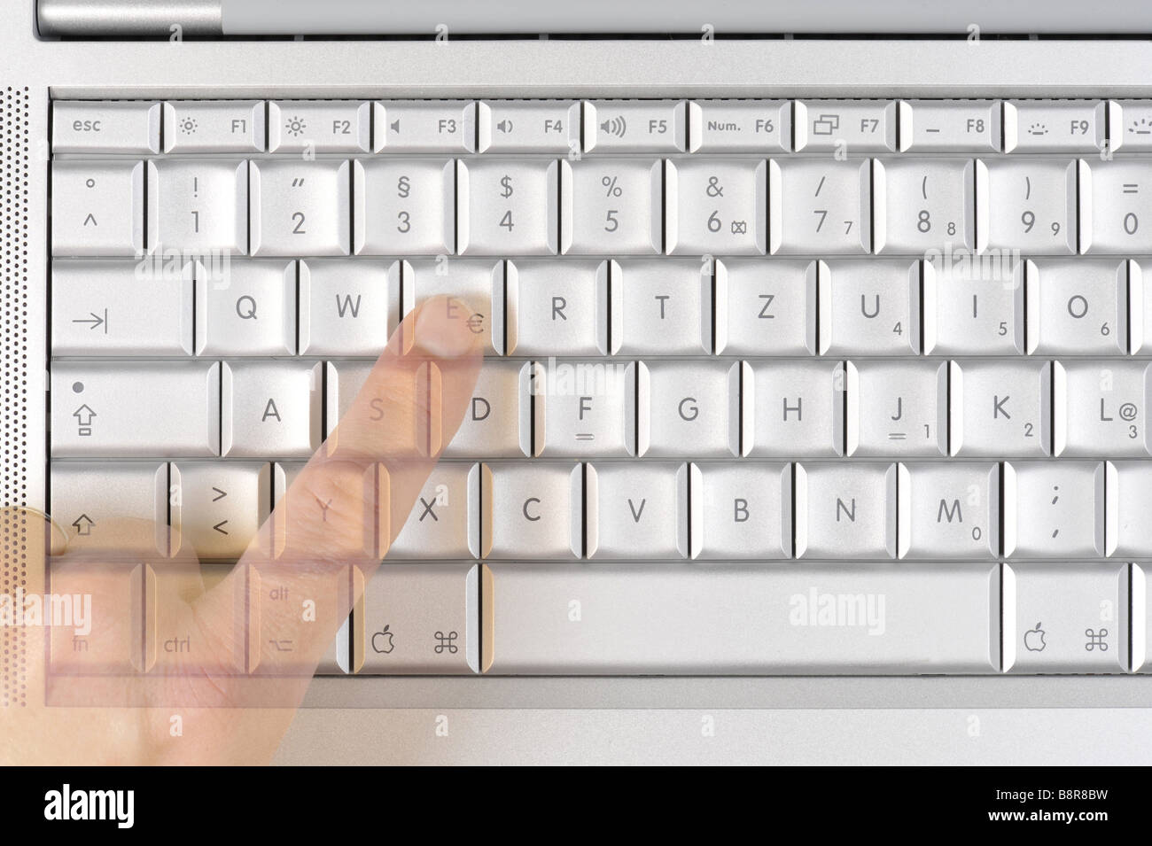 index finger typing on the letter E on an Apple MacBook Pro keyboard ...
