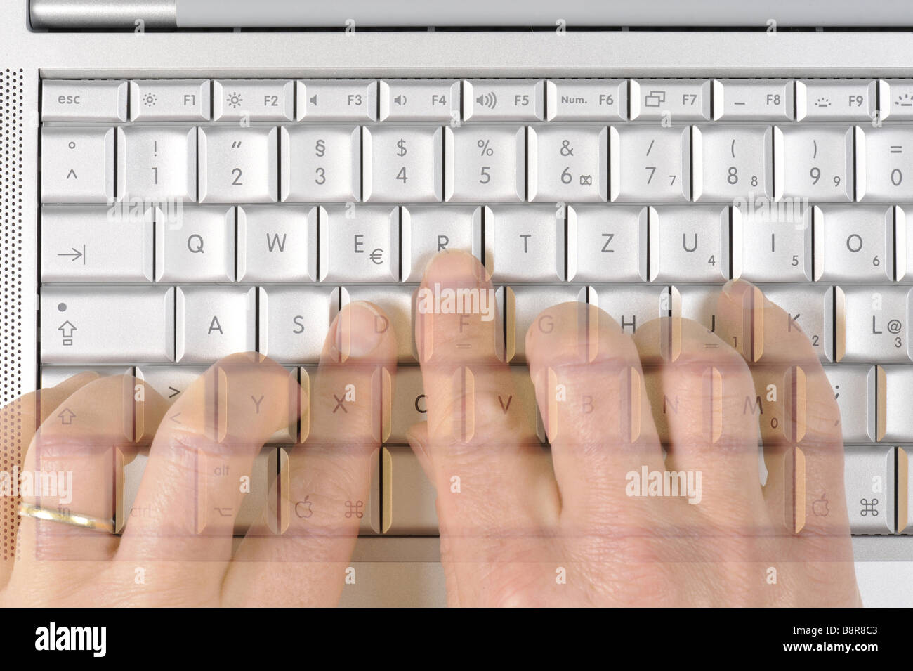 two hands typing on a Apple MacBook Pro keyboard Stock Photo - Alamy