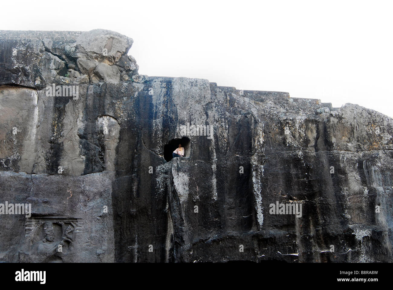 Man peering down from a cave at Ellora, Maharashtra, India Stock Photo ...