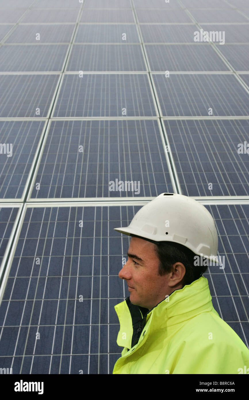 Man next to a giant energy solar panel Stock Photo - Alamy