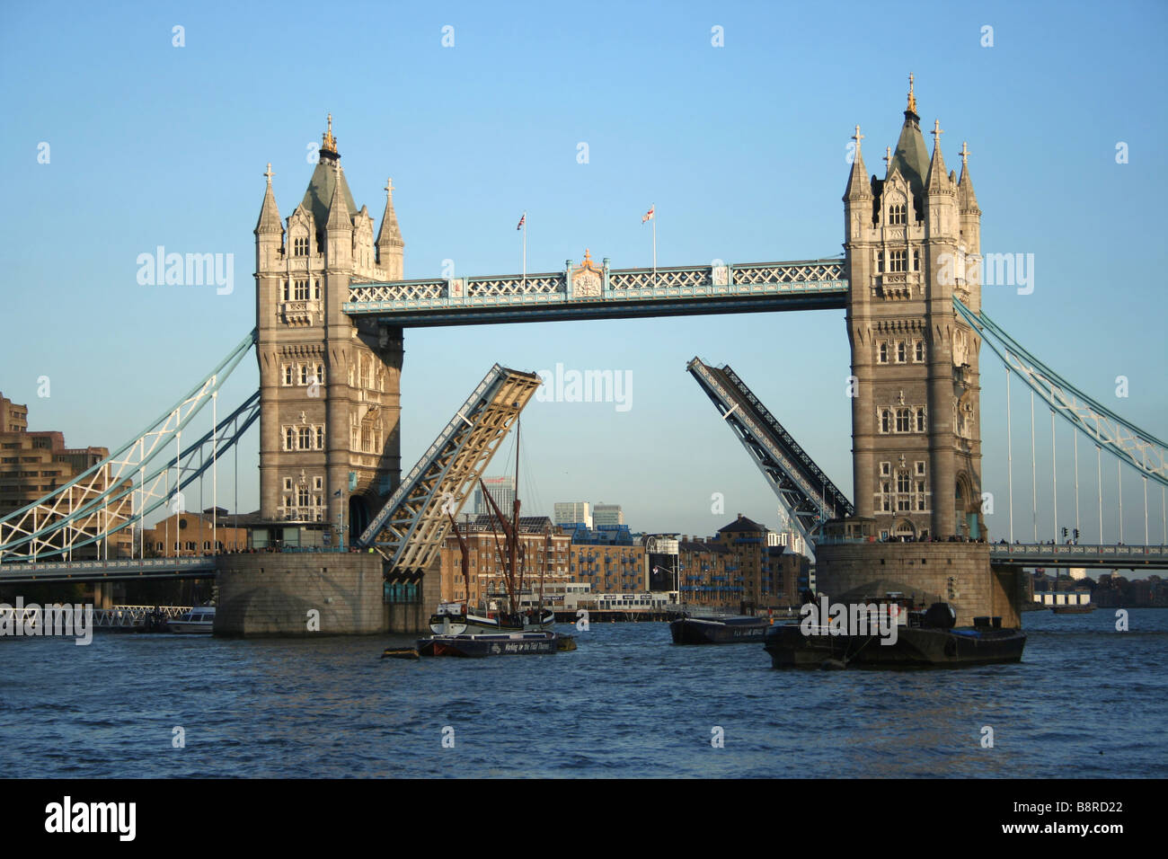yacht passing under Tower Bridge with drawbridge raised London October ...