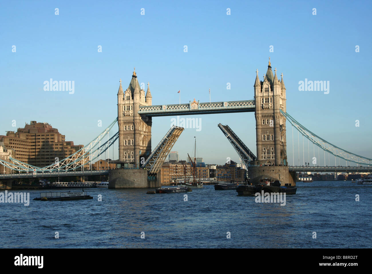 yacht passing under Tower Bridge with drawbridge raised London October ...