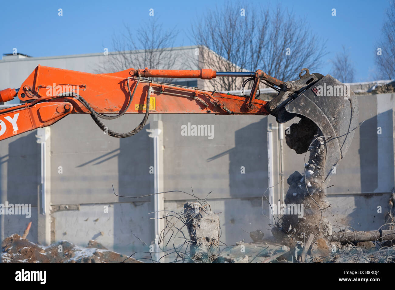 Digger emptying it's bucket of demolition debris , Finland Stock Photo ...