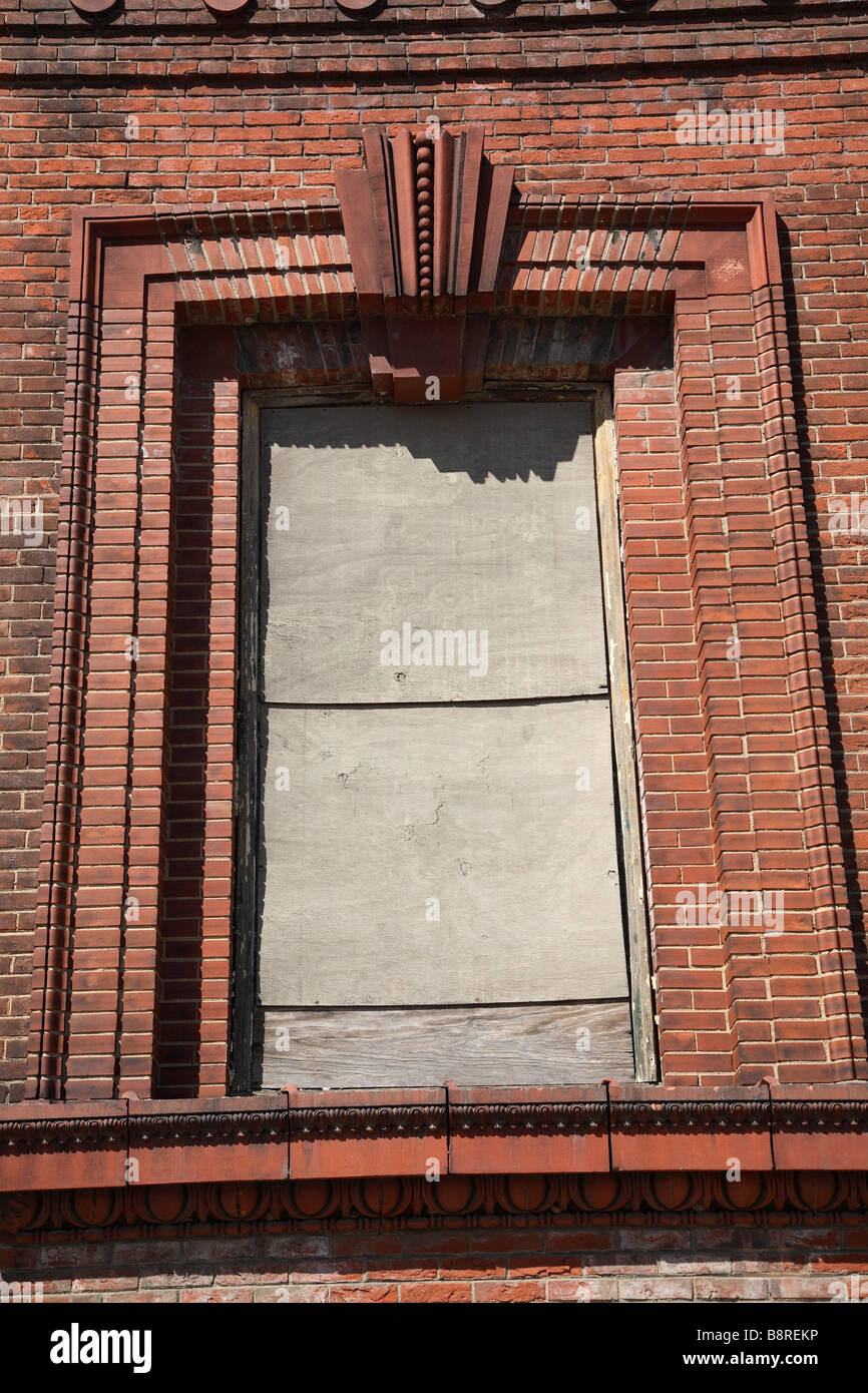 Rectangular Renaissance Revival brick window boarded up Stock Photo - Alamy