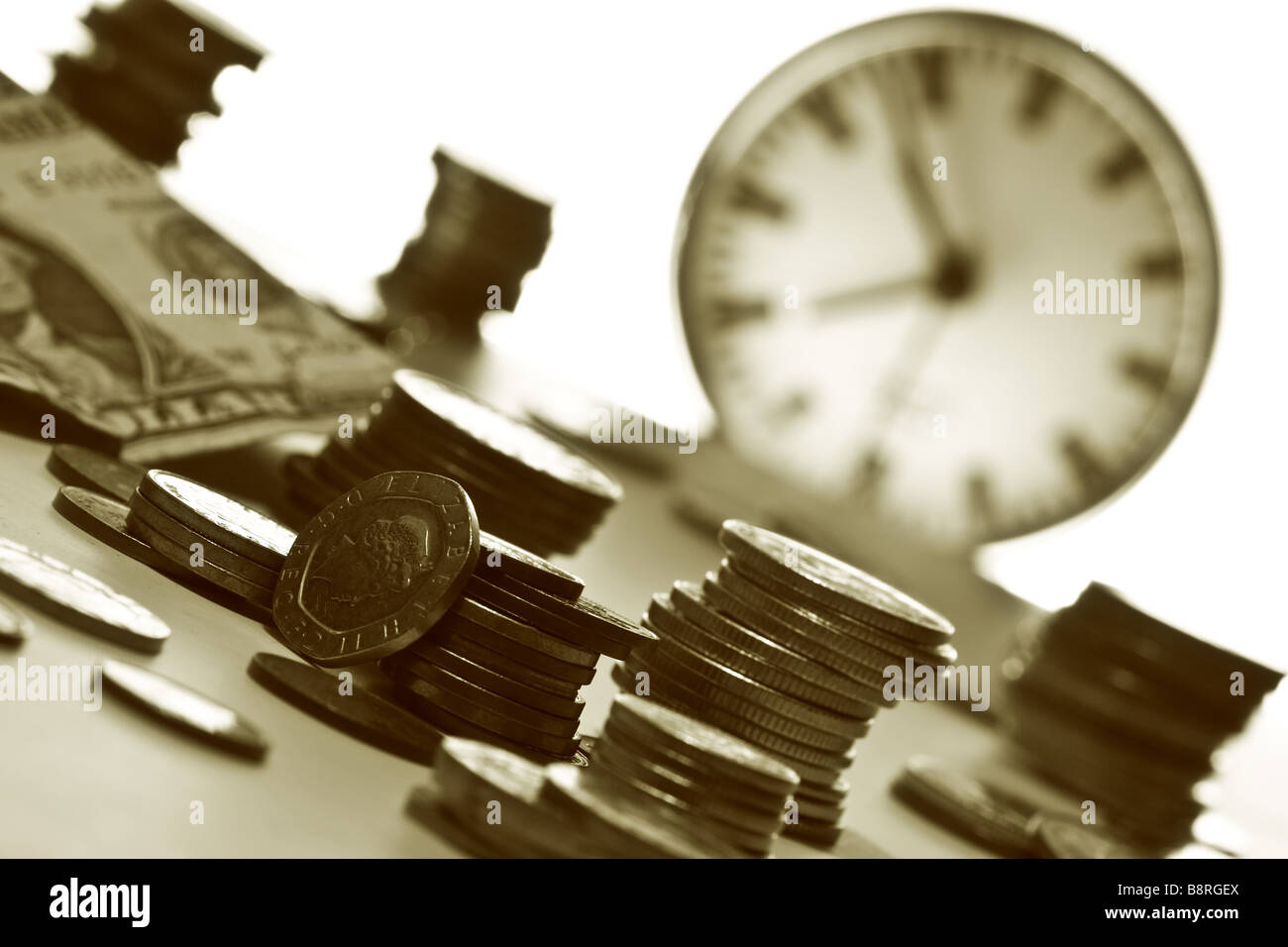 Money laid out with time (a clock) overlooking it Stock Photo - Alamy