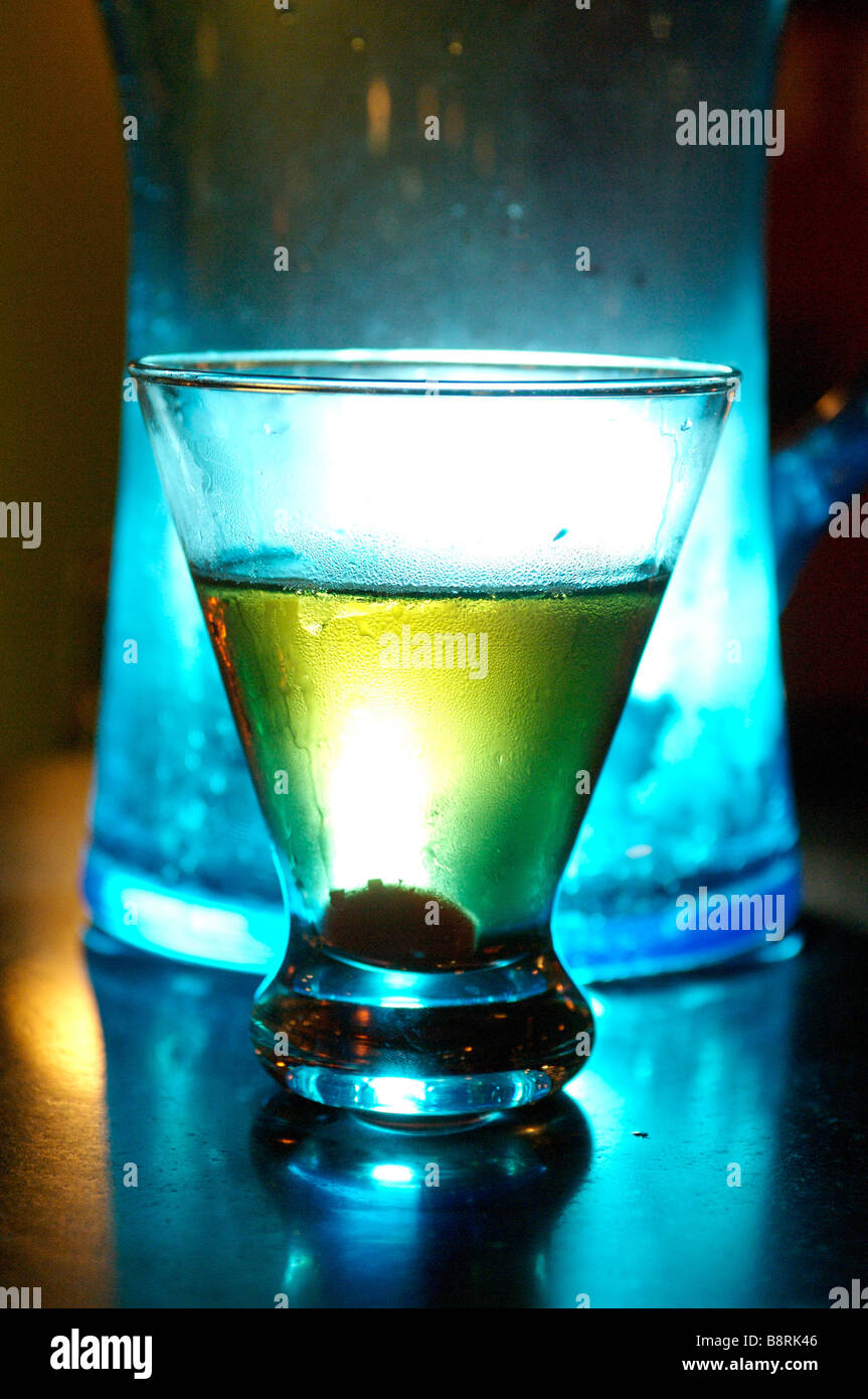 Cocktails on a dark nightclub bar top at night. Drinking in a bar or ...