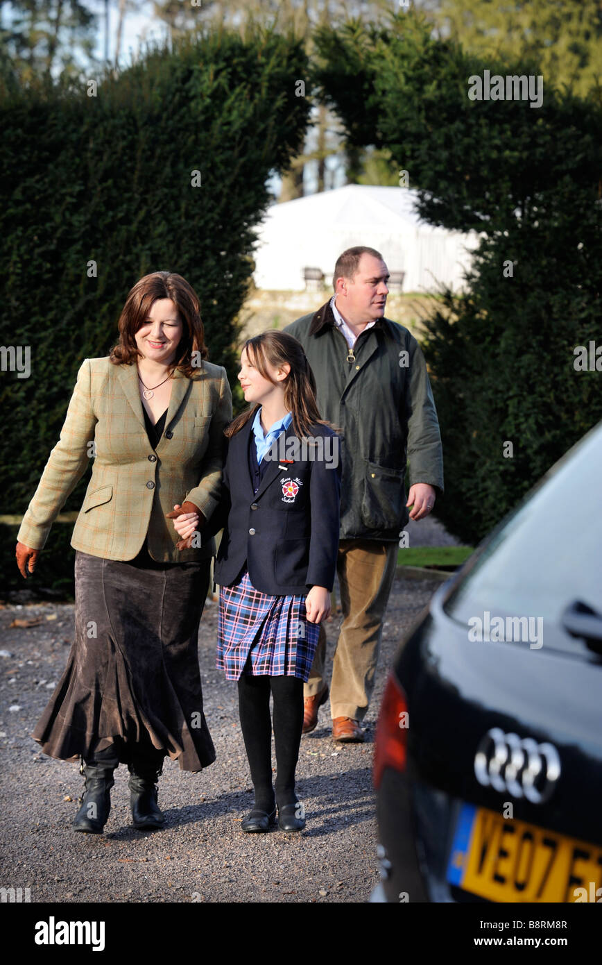 A SECURITY GUARD PROVIDES CLOSE PROTECTION WHILE A MOTHER COLLECTS HER ...