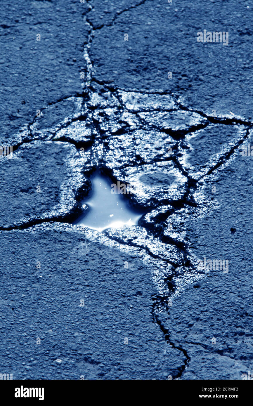 detail of hole and cracks in damaged road surface outdoors Stock Photo ...