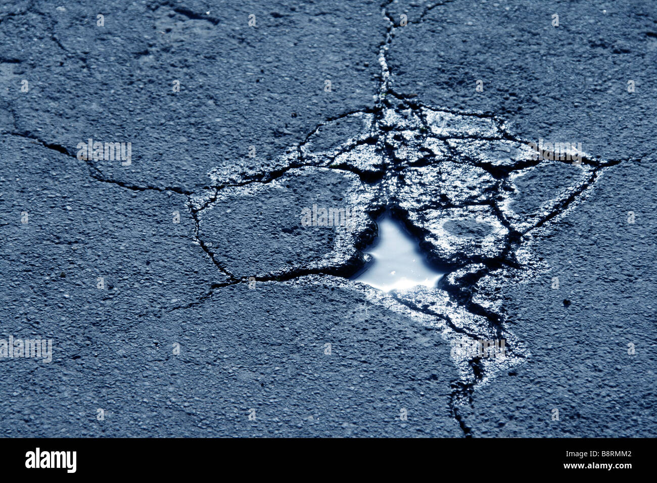 detail of hole and cracks in damaged road surface outdoors Stock Photo ...