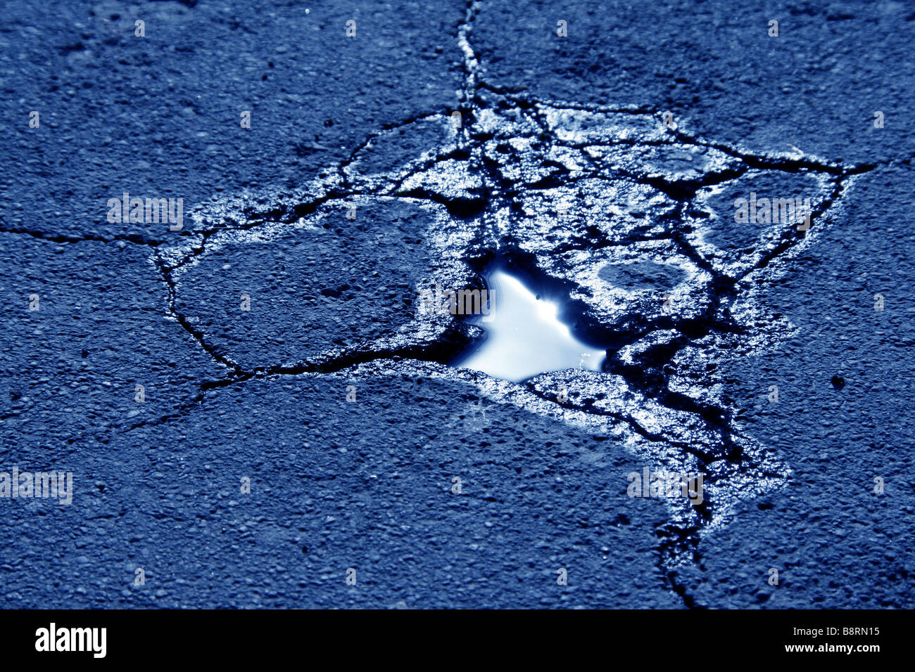 detail of hole and cracks in damaged road surface outdoors Stock Photo ...