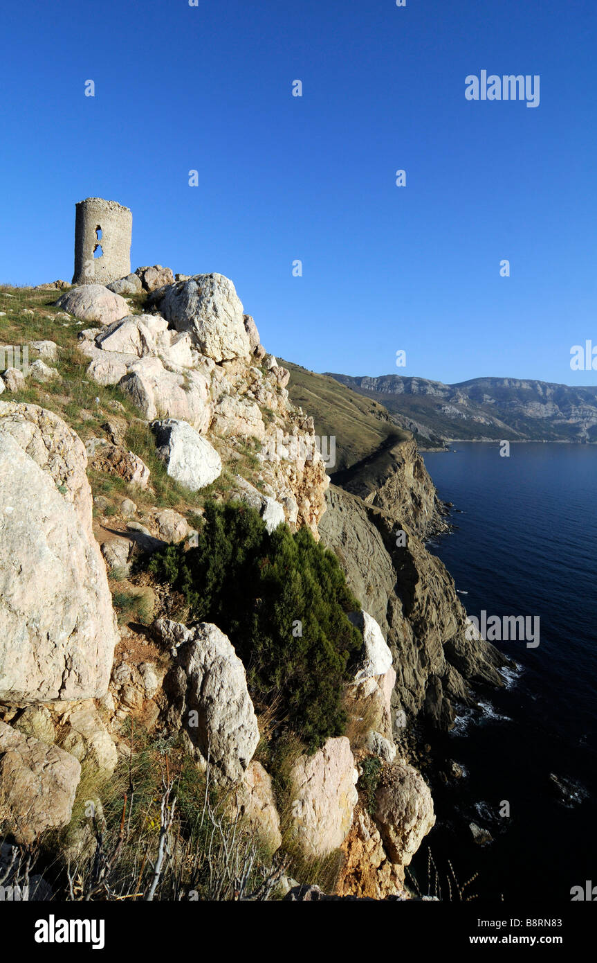 A tower ruins from a medieval Genoese fortress on a clifftop dominating ...