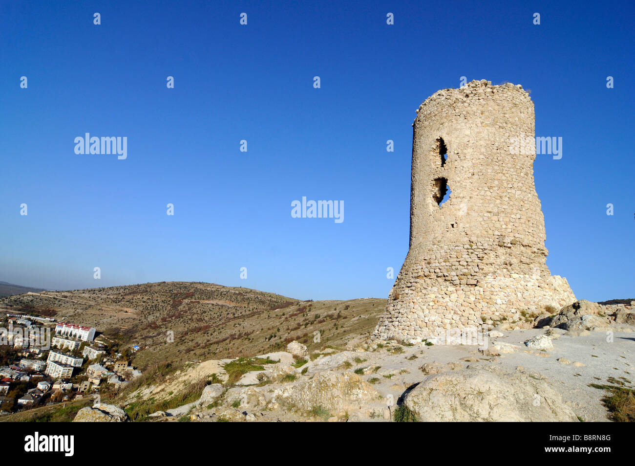 A tower ruins from a medieval Genoese fortress on a clifftop dominating ...