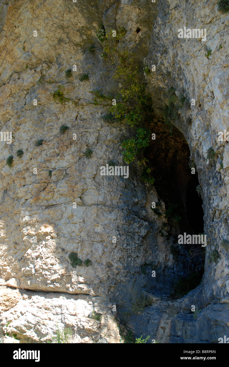 small cave entrance in limestone cliff, Vall de Laguart, Benimaurell ...