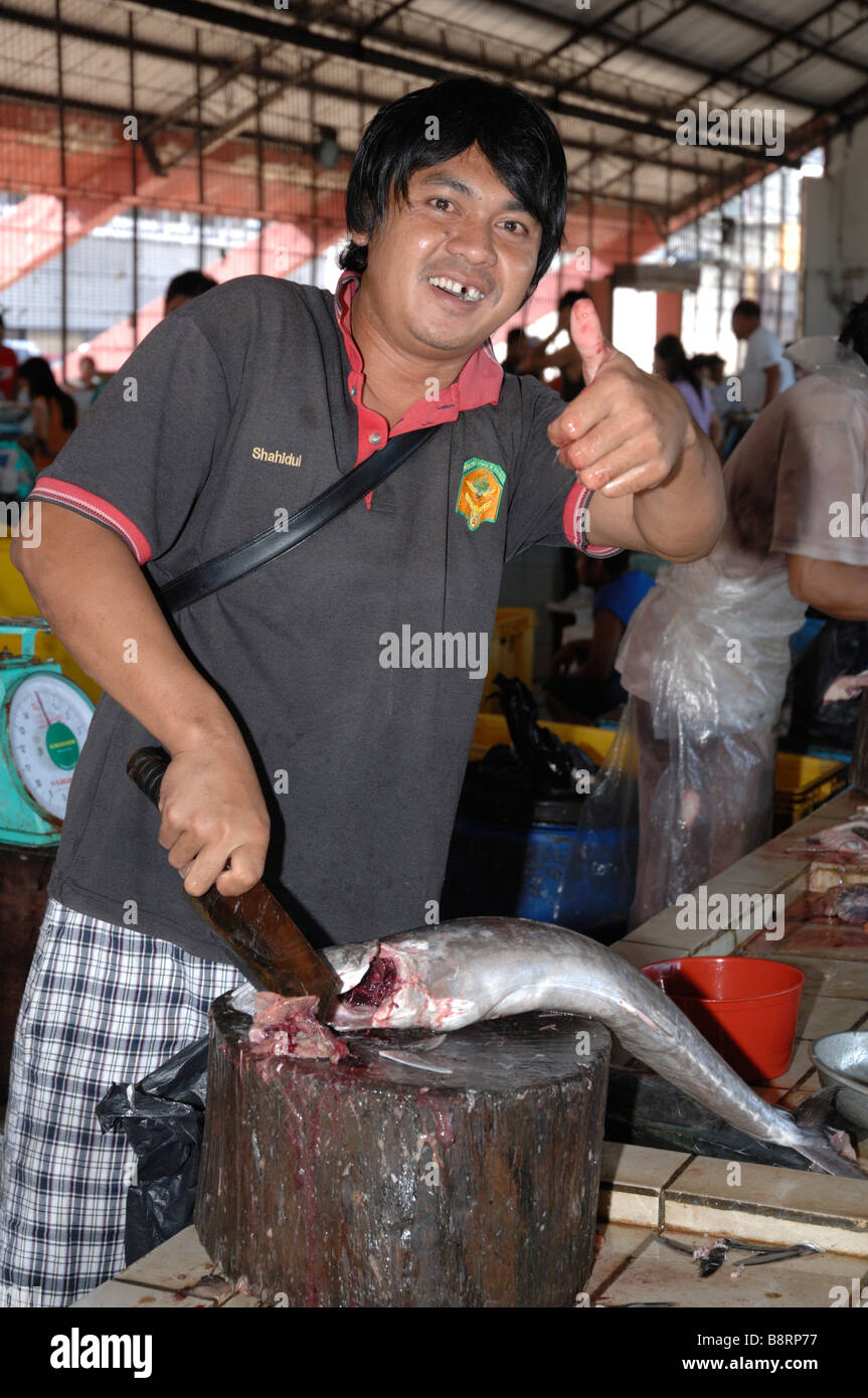 Man gutting fish interior of SAFMA fish market Kota Kinabalu Sabah ...