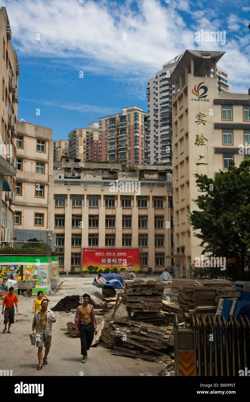Street workes in a residential area of downtown Chongqing city, China ...