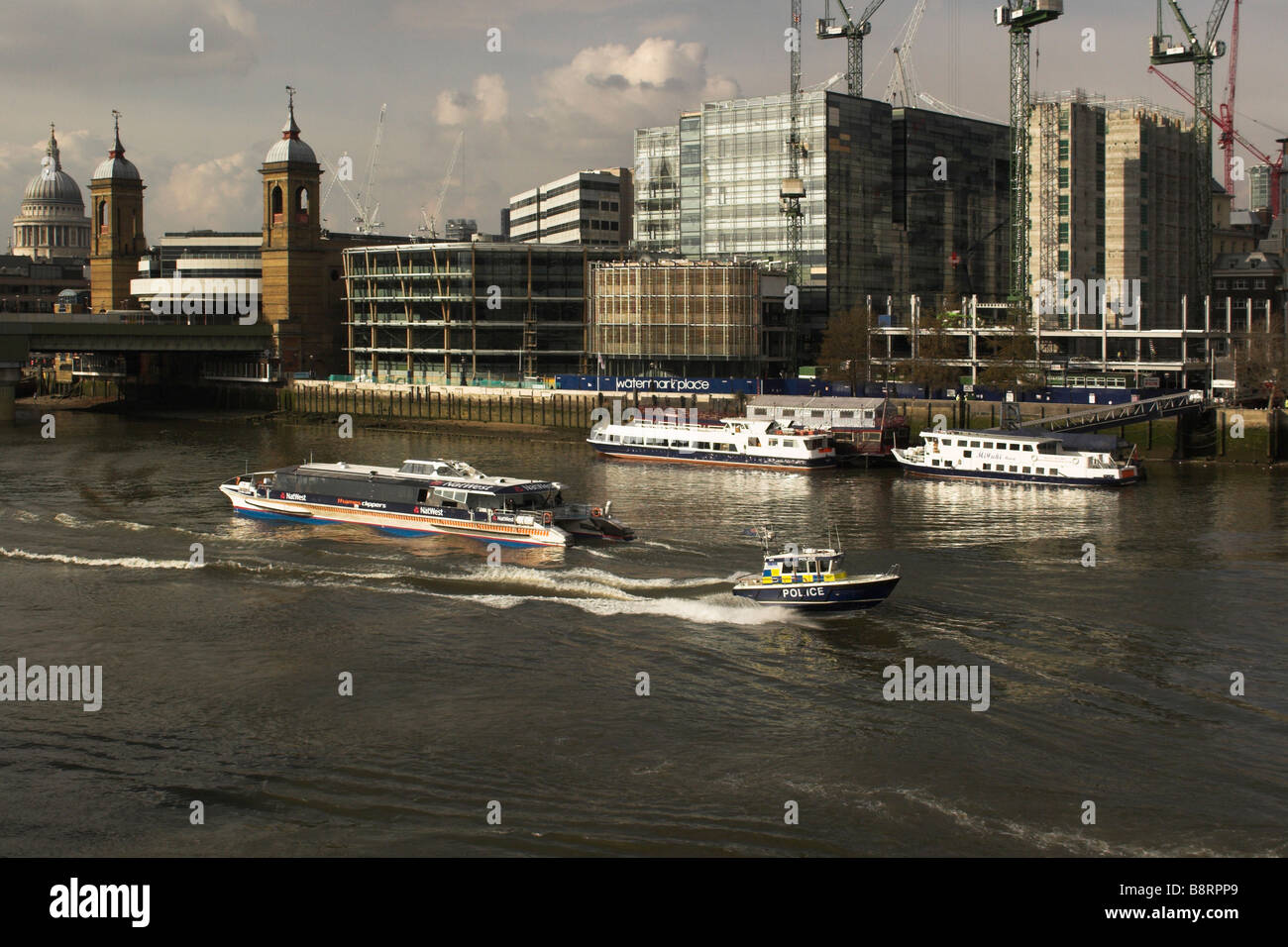 A police launch powers up the River Thames near London Bridge Stock ...