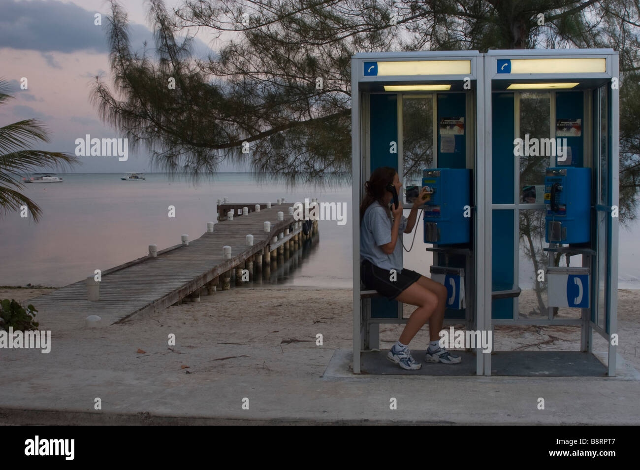 Woman in a phonebooth on the beach Stock Photo - Alamy