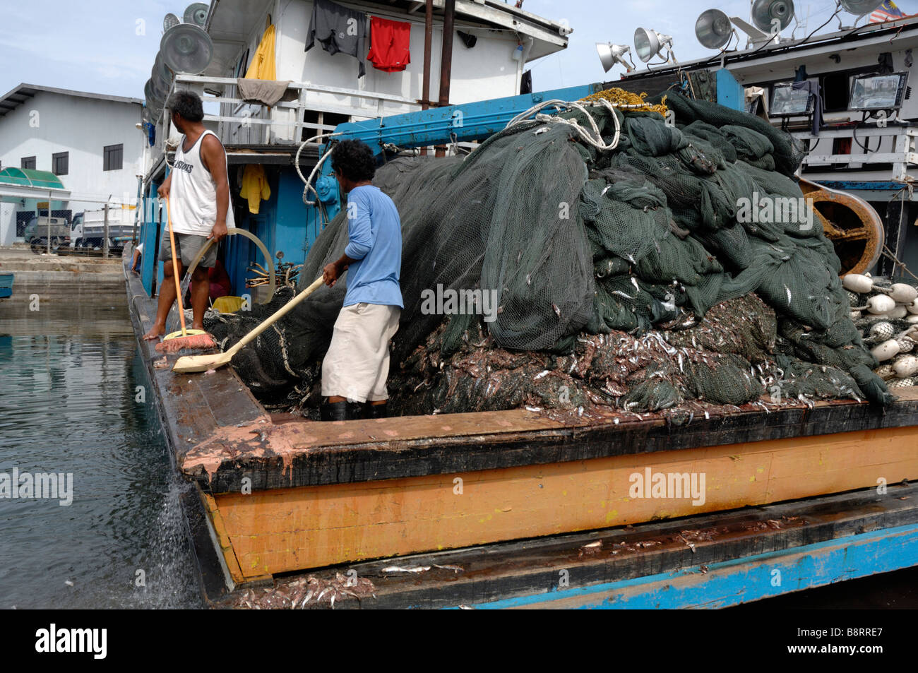 Fishermmen onboard fishing boat Semporna docks Sulu Sea Malaysia Sout ...