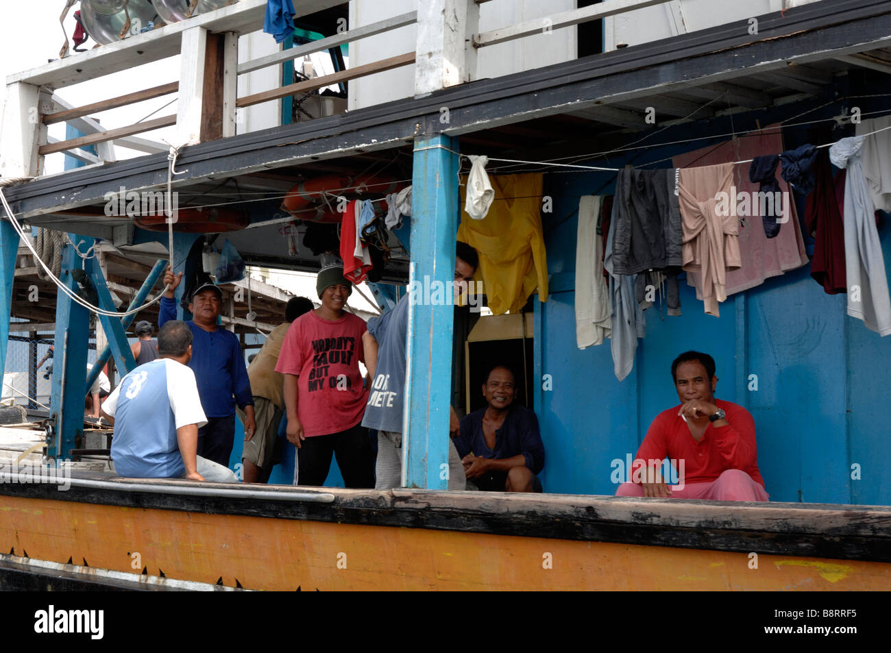 Fishermmen onboard fishing boat Semporna docks Sulu Sea Malaysia Sout ...