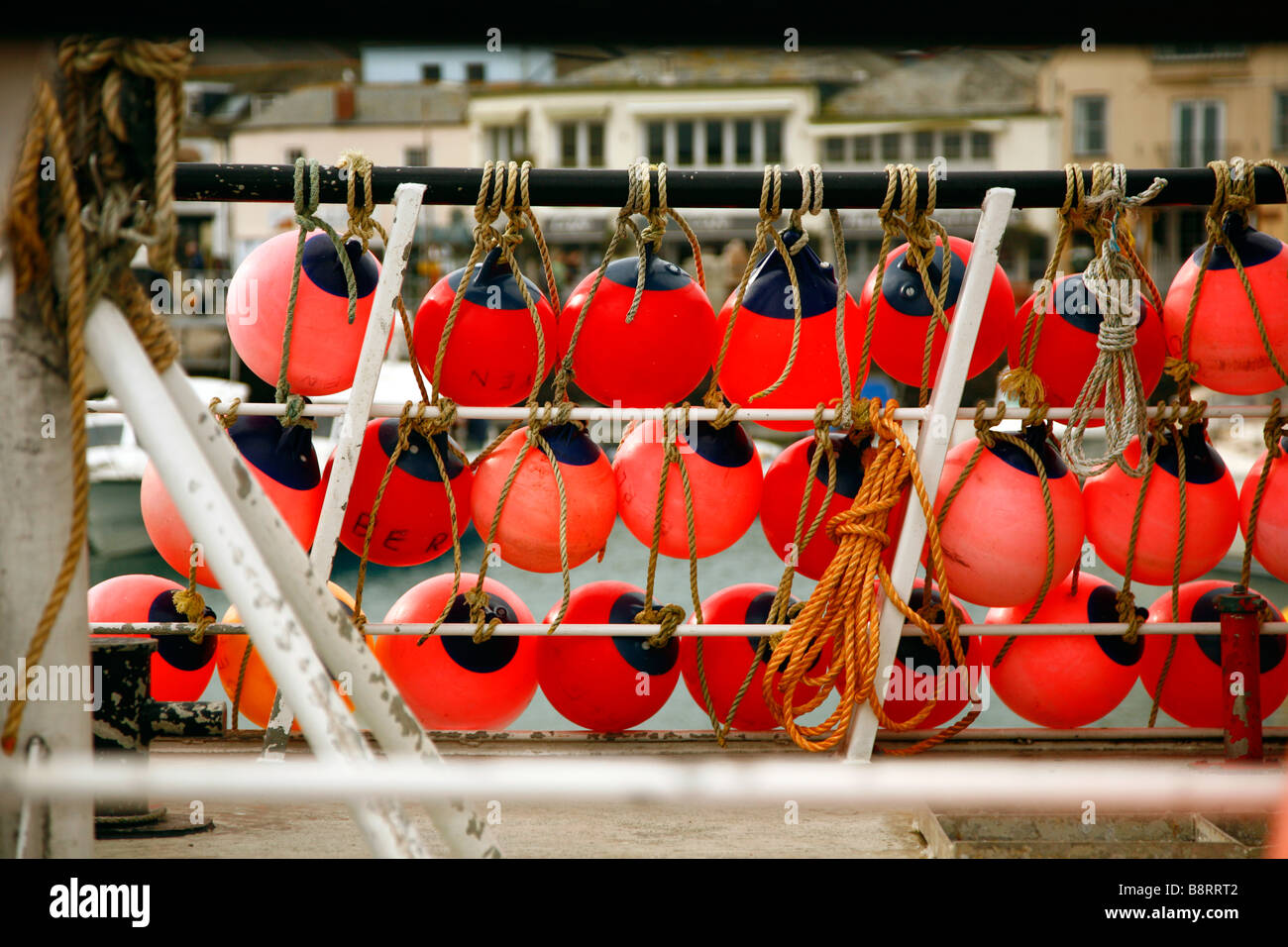 Bright Red round net floats on a fishing boat at Padstow Cornwall ...